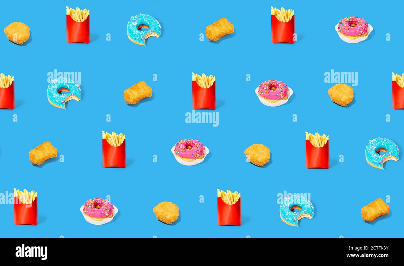Creative pattern with junk food on blue background. French fries ...