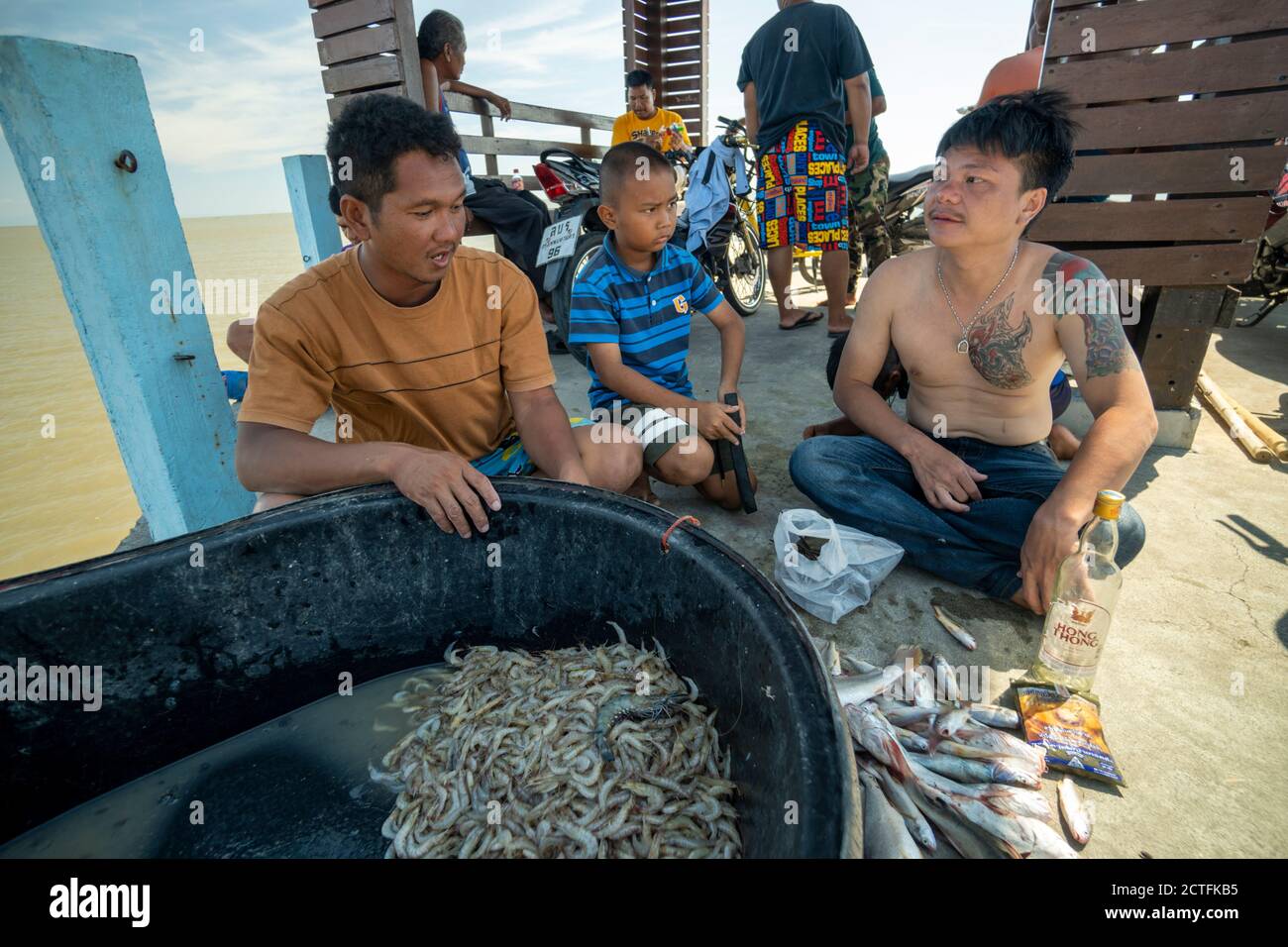 Thai fishermen with small catch Stock Photo - Alamy