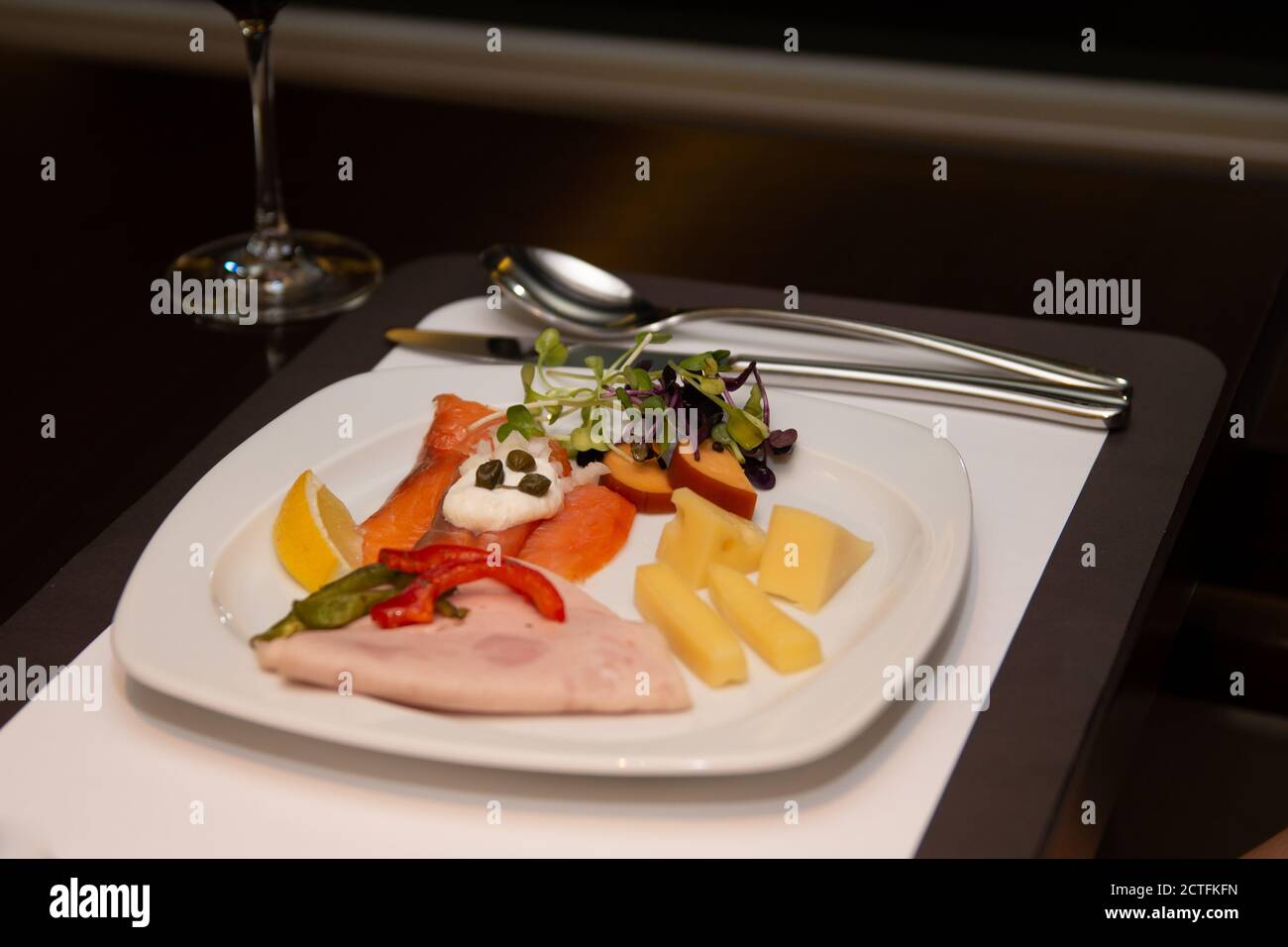 Morning buffet breakfast with a slice of ham and fruits with knife and ...