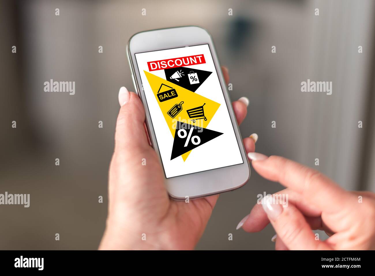 Discount concept on a smartphone held by a hand Stock Photo - Alamy