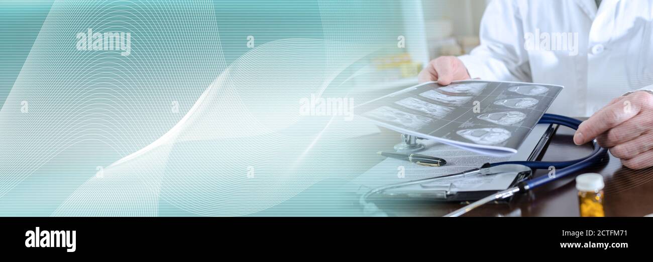 Doctor holding a mri scan at his desk; panoramic banner Stock Photo - Alamy