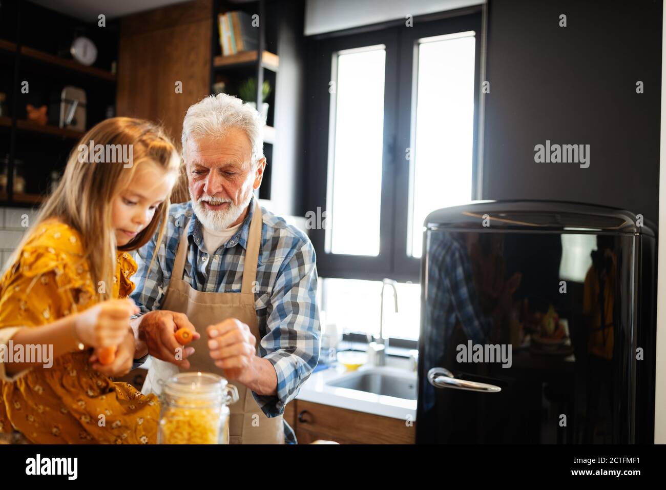 Smiling grandparents having breakfast with their granddaughter Stock ...