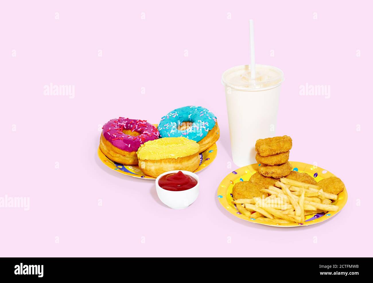 Junk food meal on pink background. French fries, chicken nuggets, sweet ...