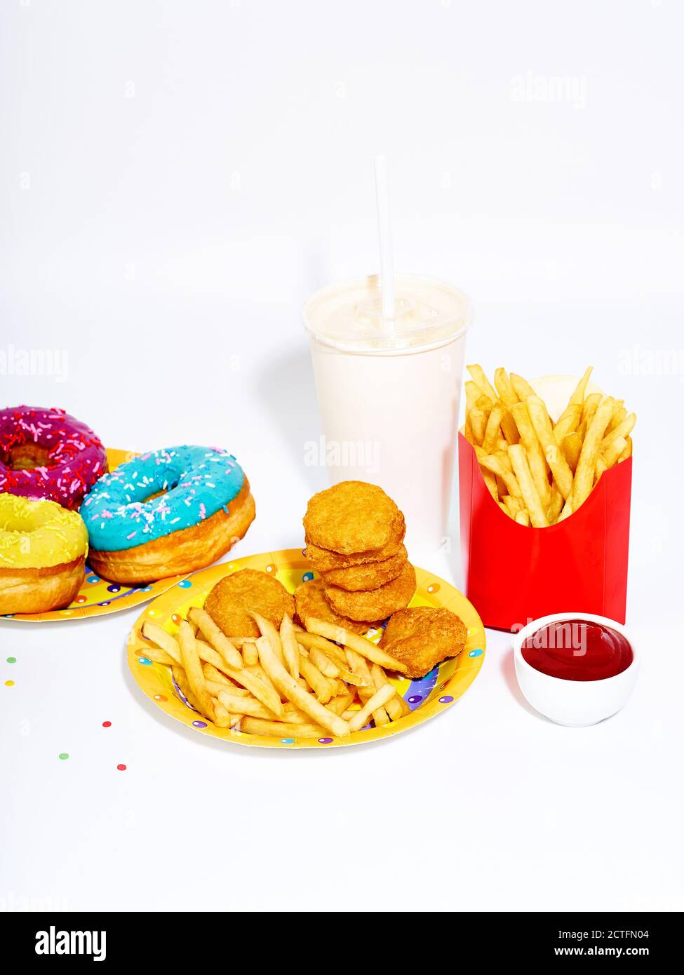 Junk food meal on white background. French fries, chicken nuggets ...