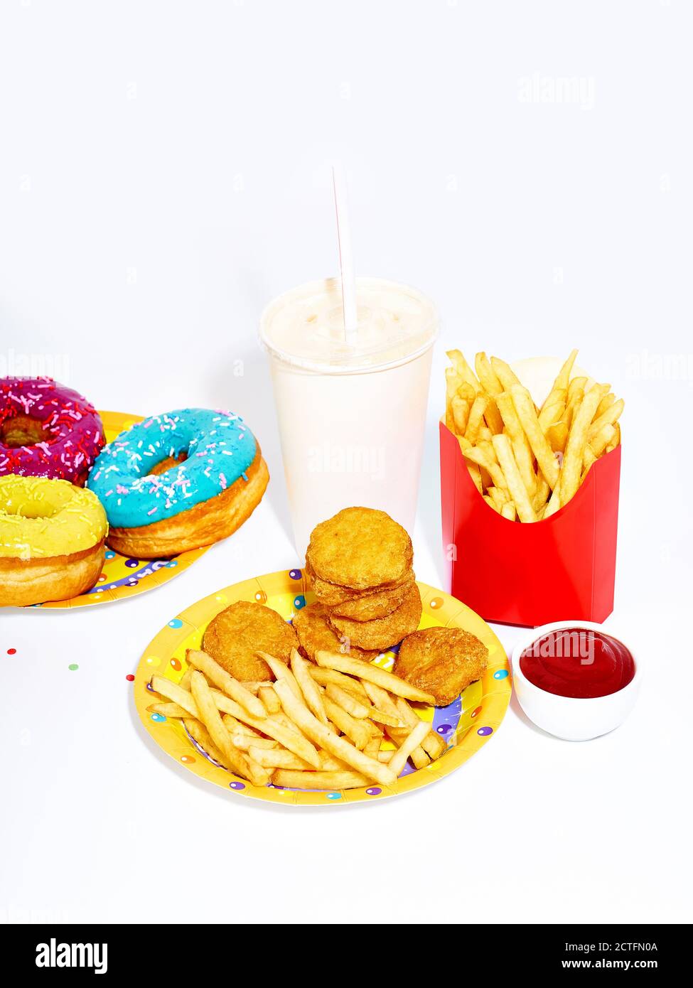 Junk food meal on white background. French fries, chicken nuggets ...
