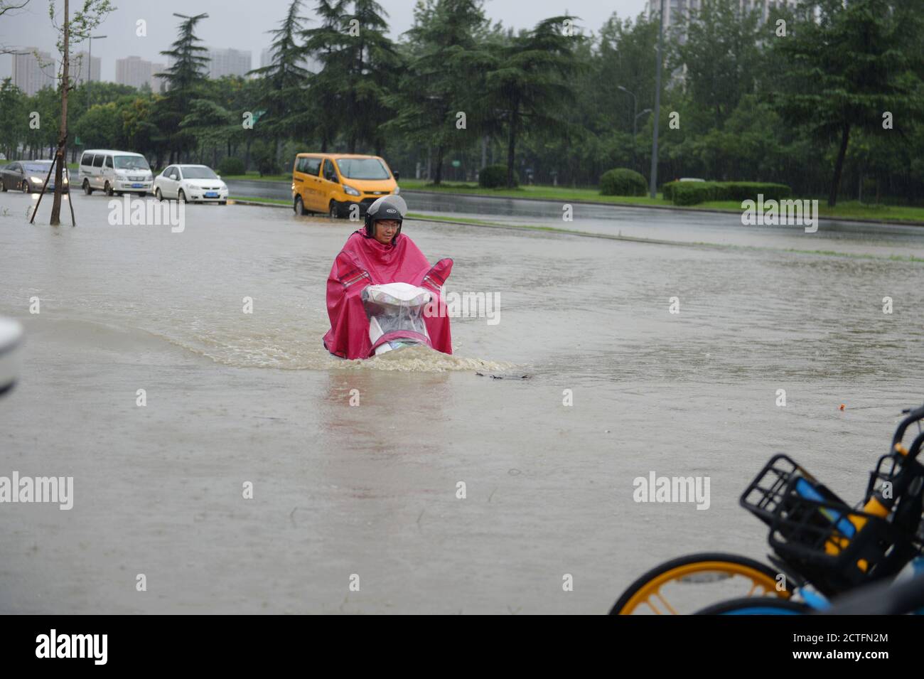 People travel through the city logging caused by heavy rainfall in ...
