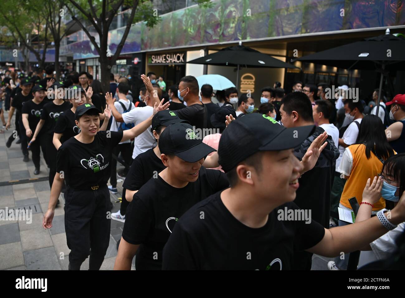 People line up to get burgers at the Shake Shack store at Sanlitun in ...