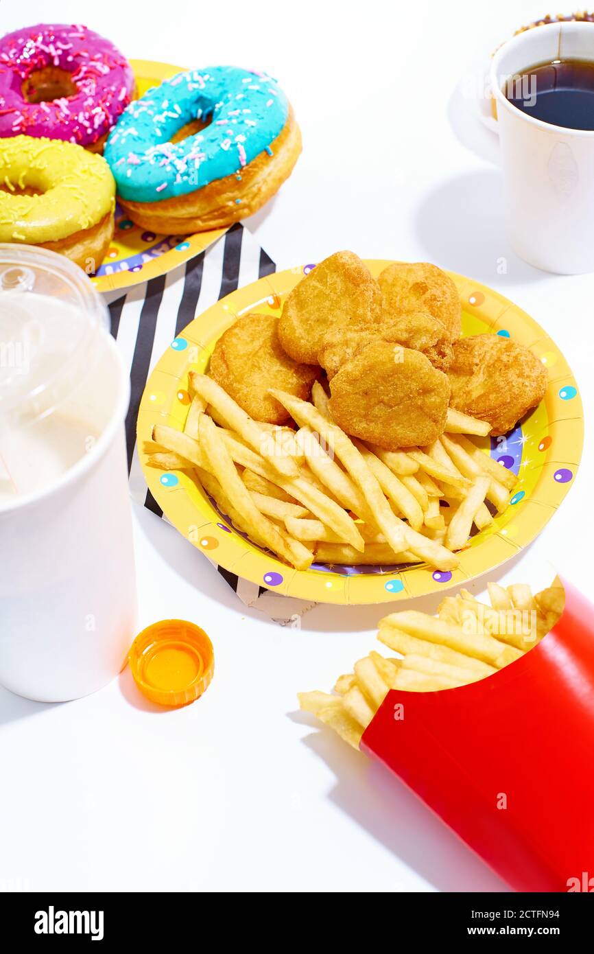 Fast food from top on white background. French fries, chicken nuggets ...