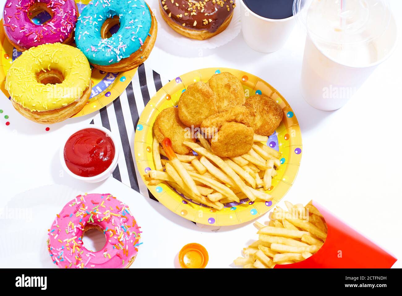 Fast food from top on white background. French fries, chicken nuggets ...
