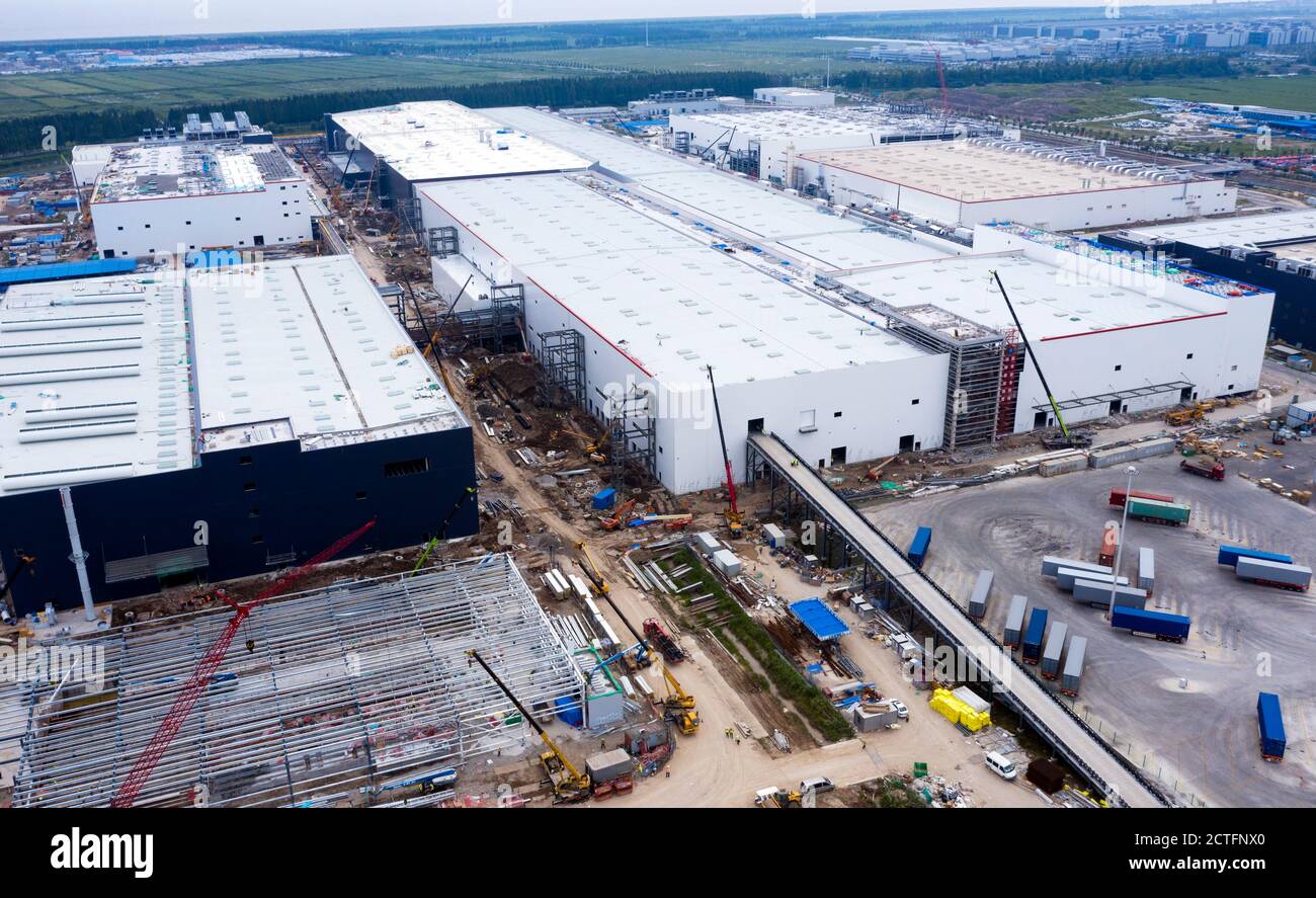 An aerial view of workers, with help of cranes and other construction ...