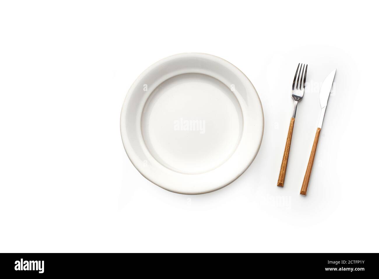 Flat lay white empty plate and cutlery isolated on white background ...
