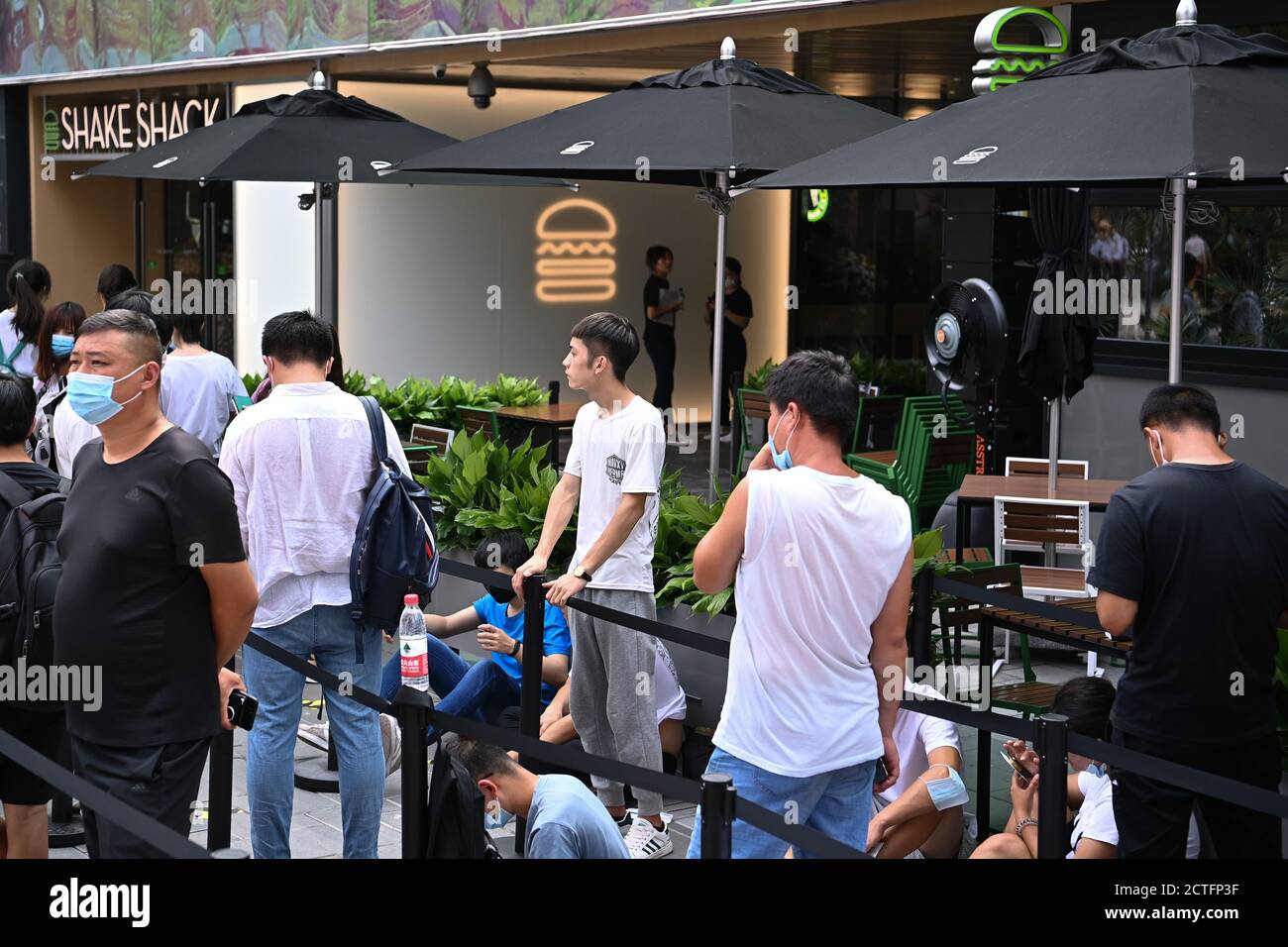 People line up to get burgers at the Shake Shack store at Sanlitun in ...
