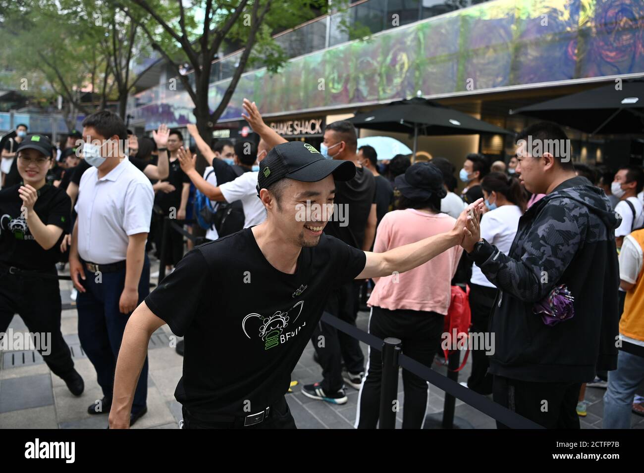 People line up to get burgers at the Shake Shack store at Sanlitun in ...