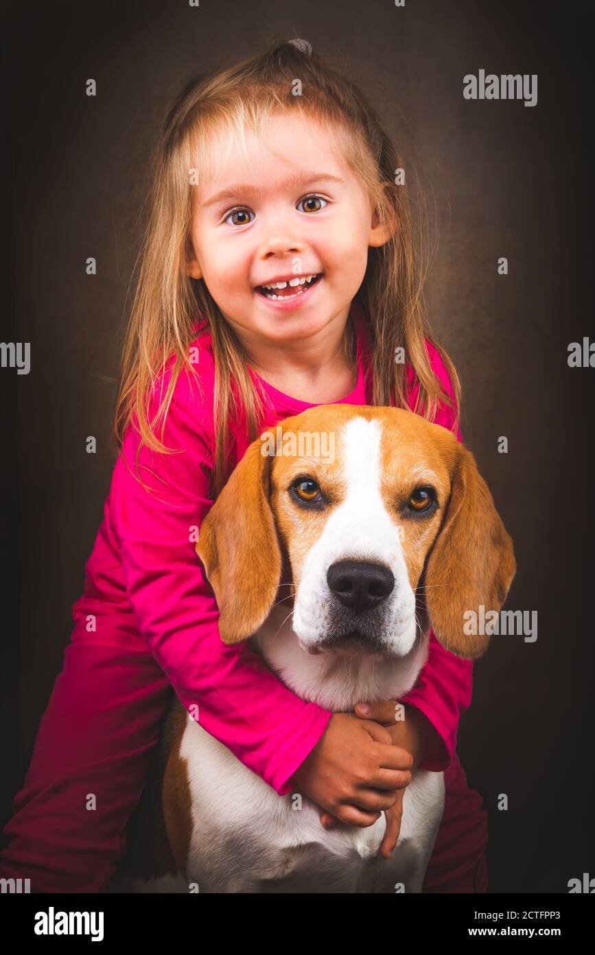 2 yeras old child hugging best friend dog. Happy childhood with pet ...