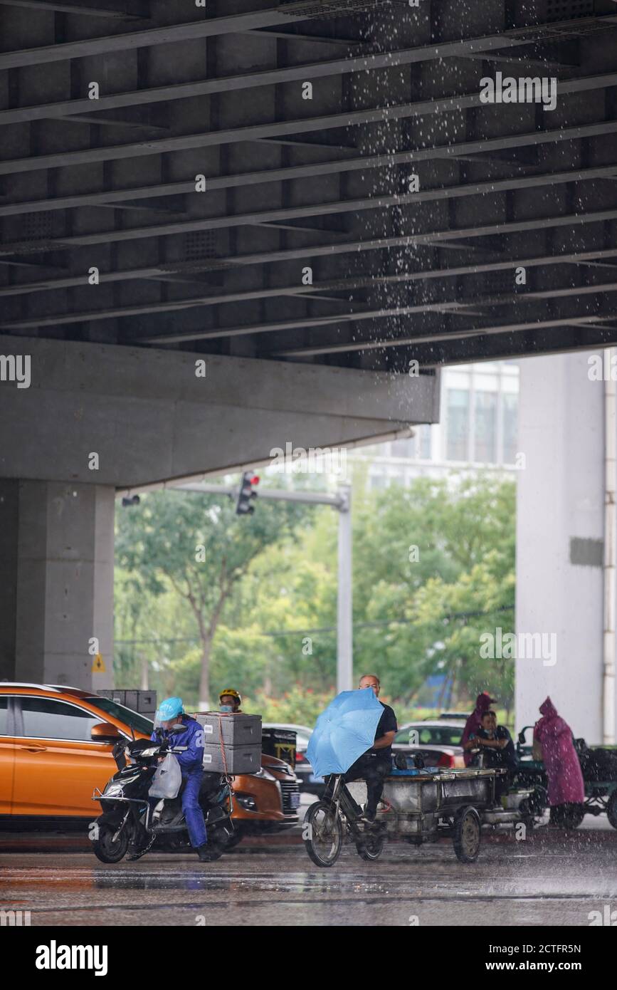 Motor, pedestrians and vehicles trek in the downpour, Beijing, China ...