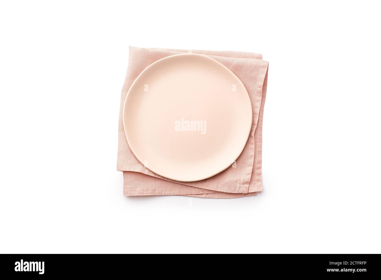 Flat lay pink matt ceramic empty plate and pink linen cloth isolated on ...