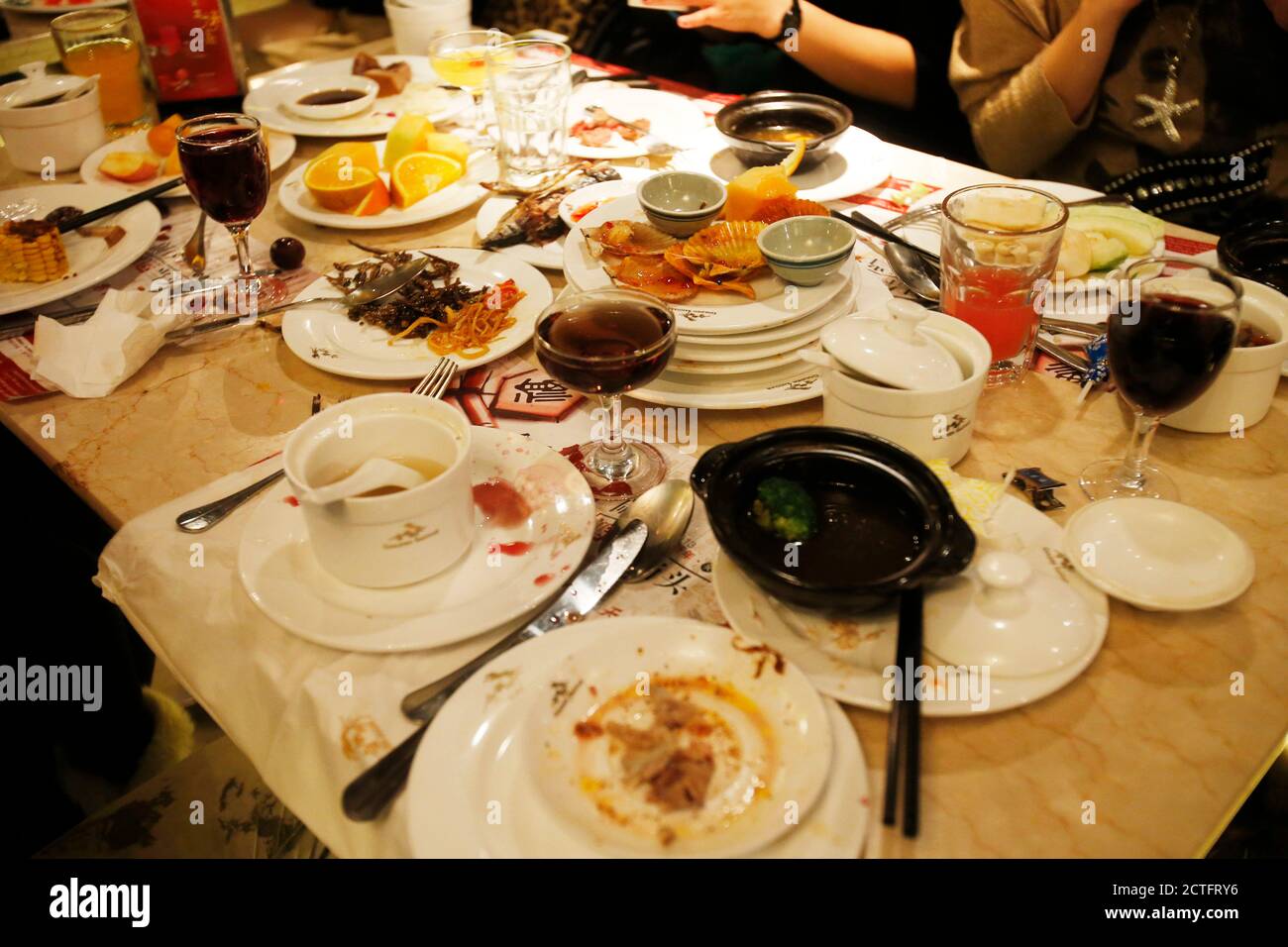 --FILE--Waiters clean plates at a buffet restaurant where food waste is ...