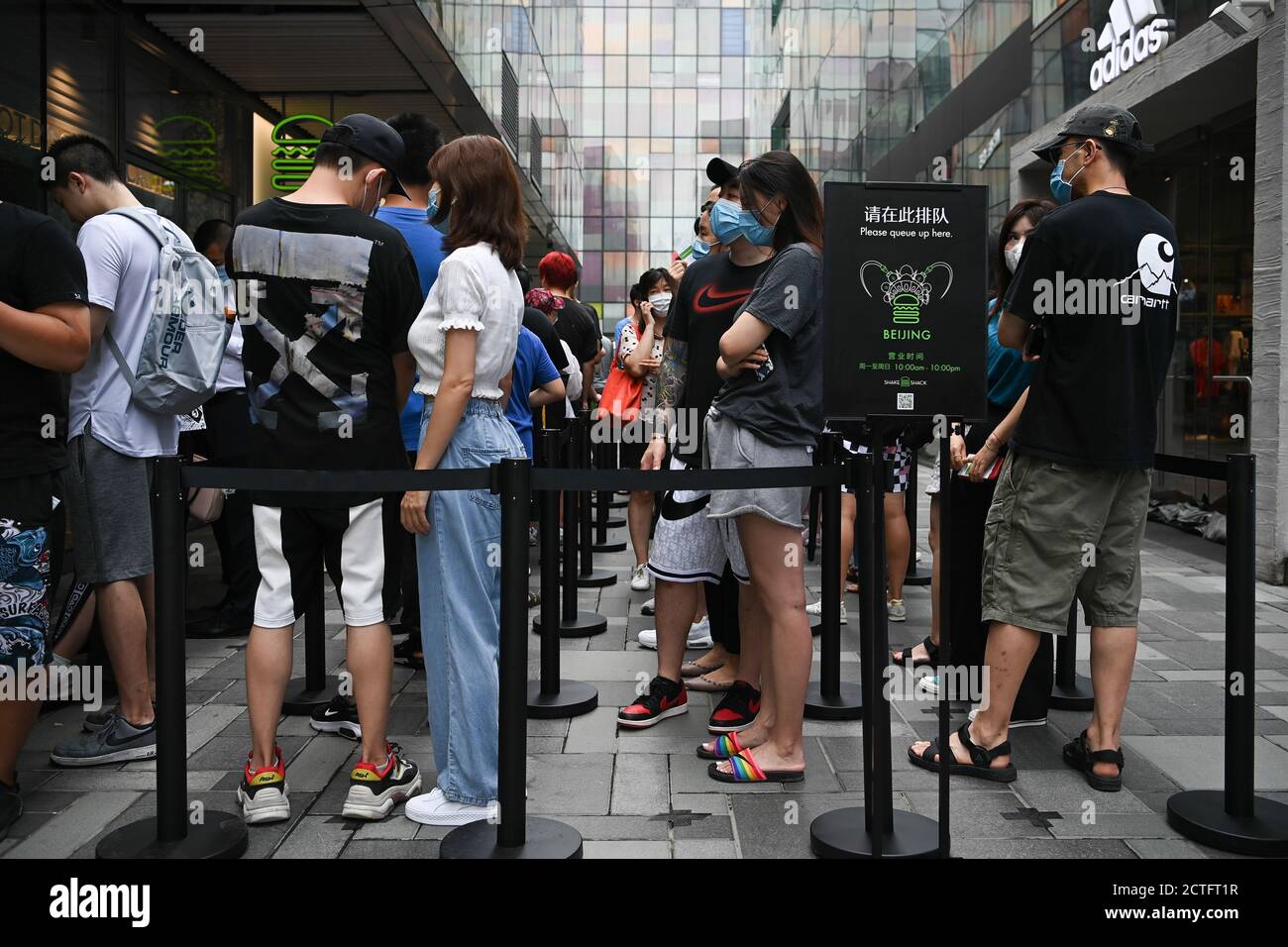 People line up to get burgers at the Shake Shack store at Sanlitun in ...
