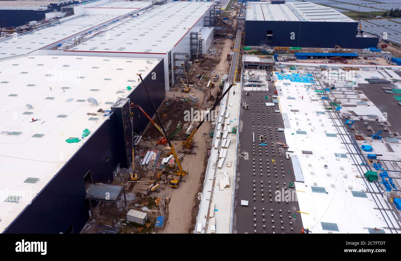 An aerial view of workers, with help of cranes and other construction ...