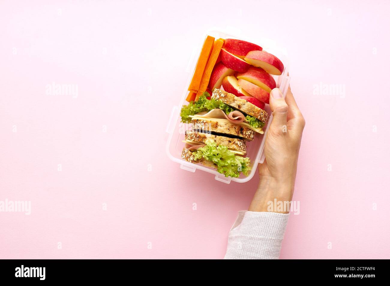 Woman holding a school lunch top view. Healthy nutritious meal in ...