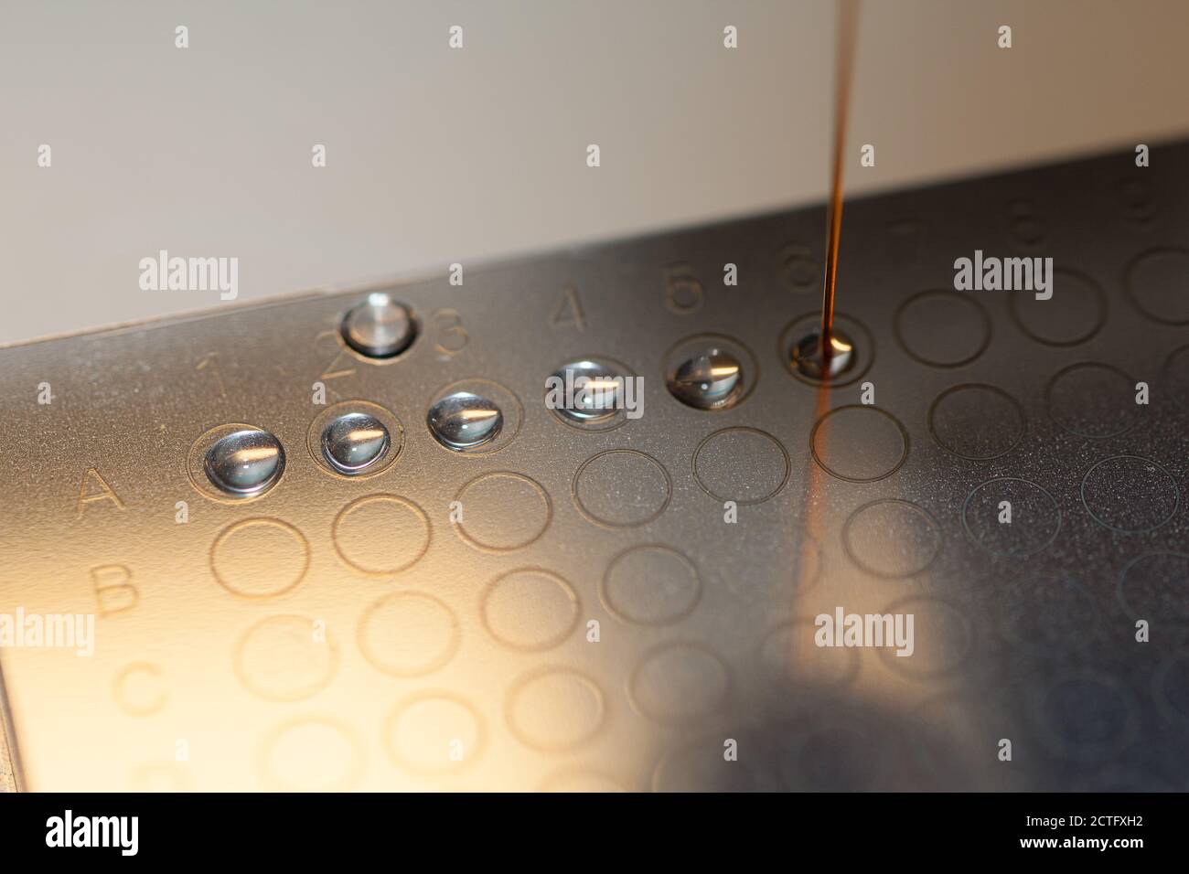 A scientist or chemist observes chemical reactions to substances in a ...