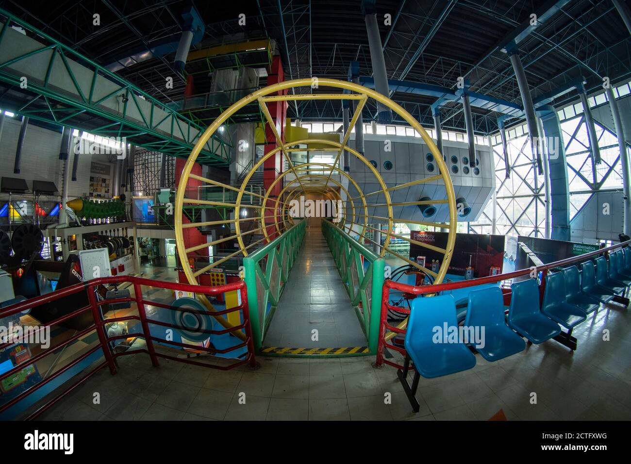 Yellow metal tunnel cage walkway Stock Photo - Alamy