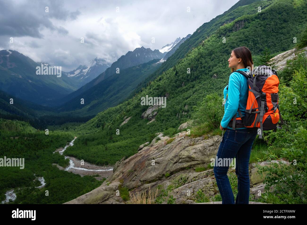 Backpacker on top of a mountain enjoying valley view. wanderlust travel ...