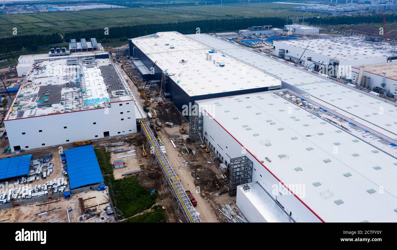 An aerial view of workers, with help of cranes and other construction ...
