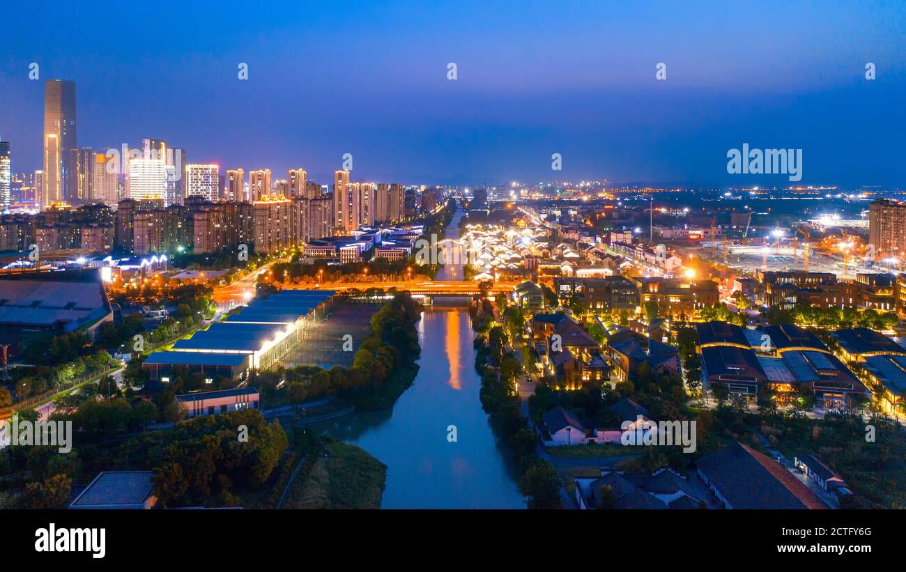 An aerial view of edifices with lights on standing in the Dream Town ...