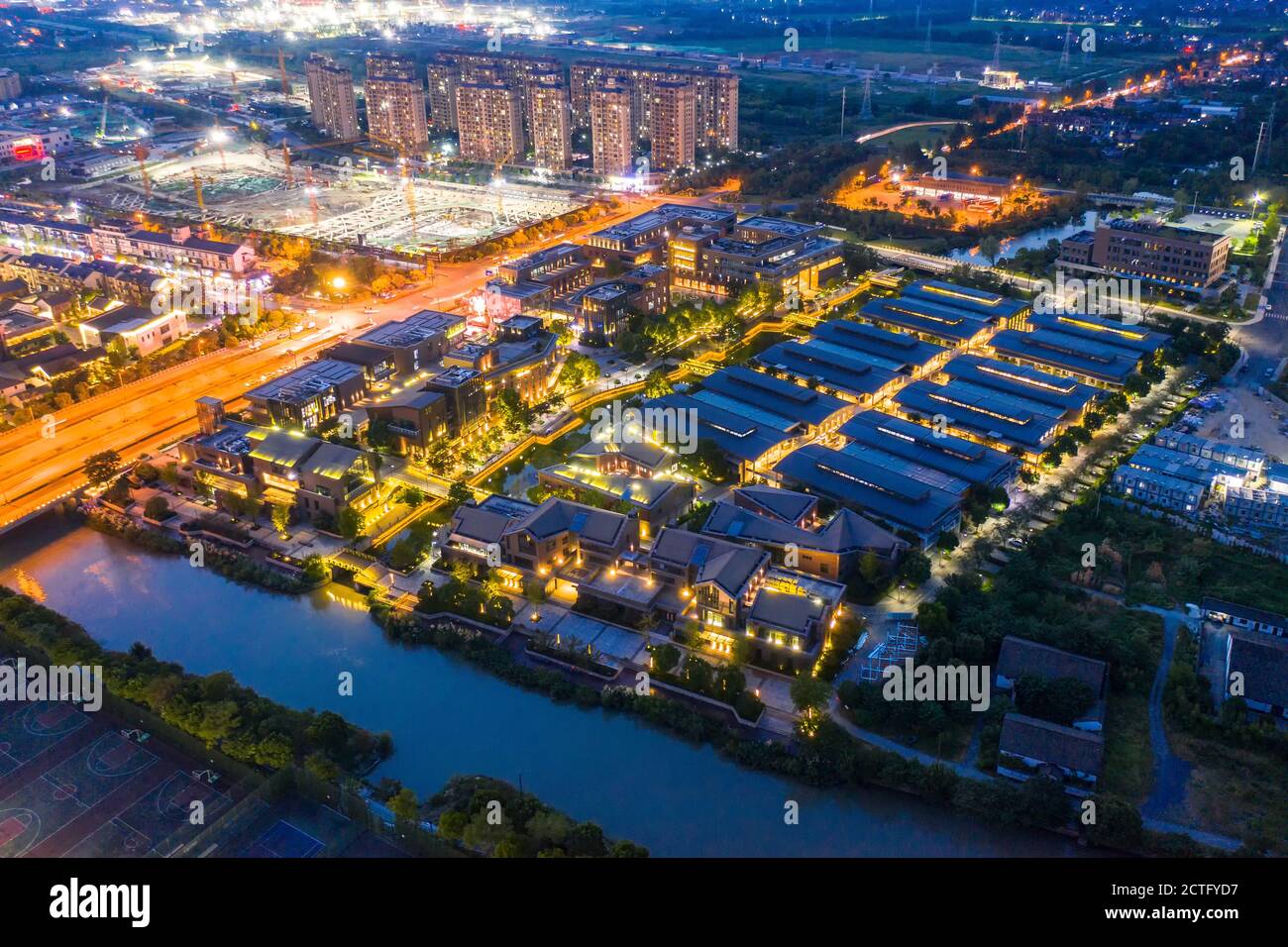 An aerial view of edifices with lights on standing in the Dream Town ...