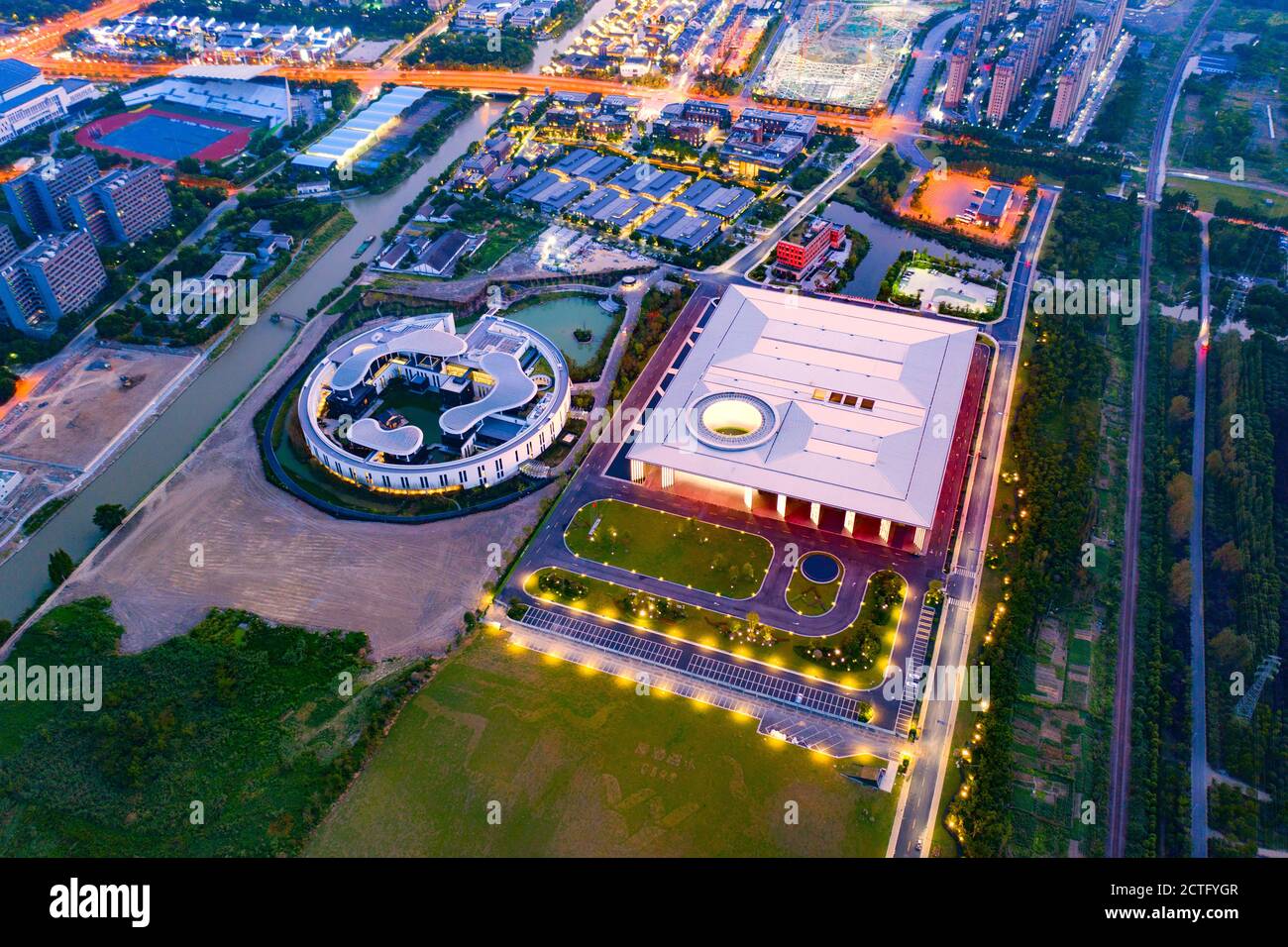 An aerial view of edifices with lights on standing in the Dream Town ...