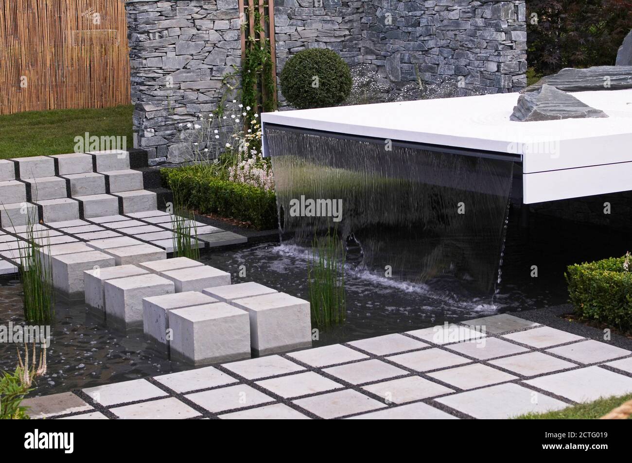 A modern water garden with stepping stones making a stricking feature ...