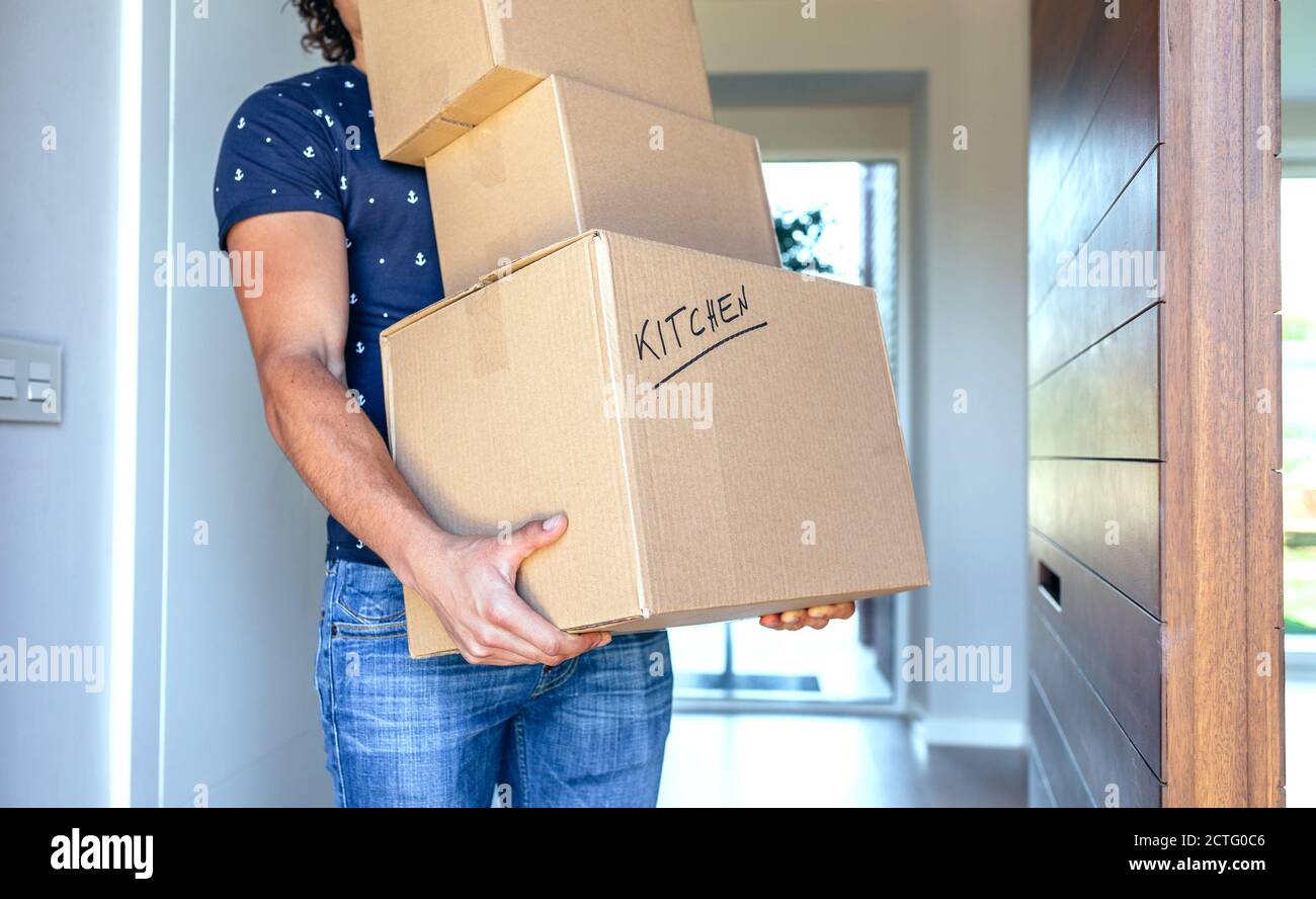 Man carrying moving boxes Stock Photo - Alamy