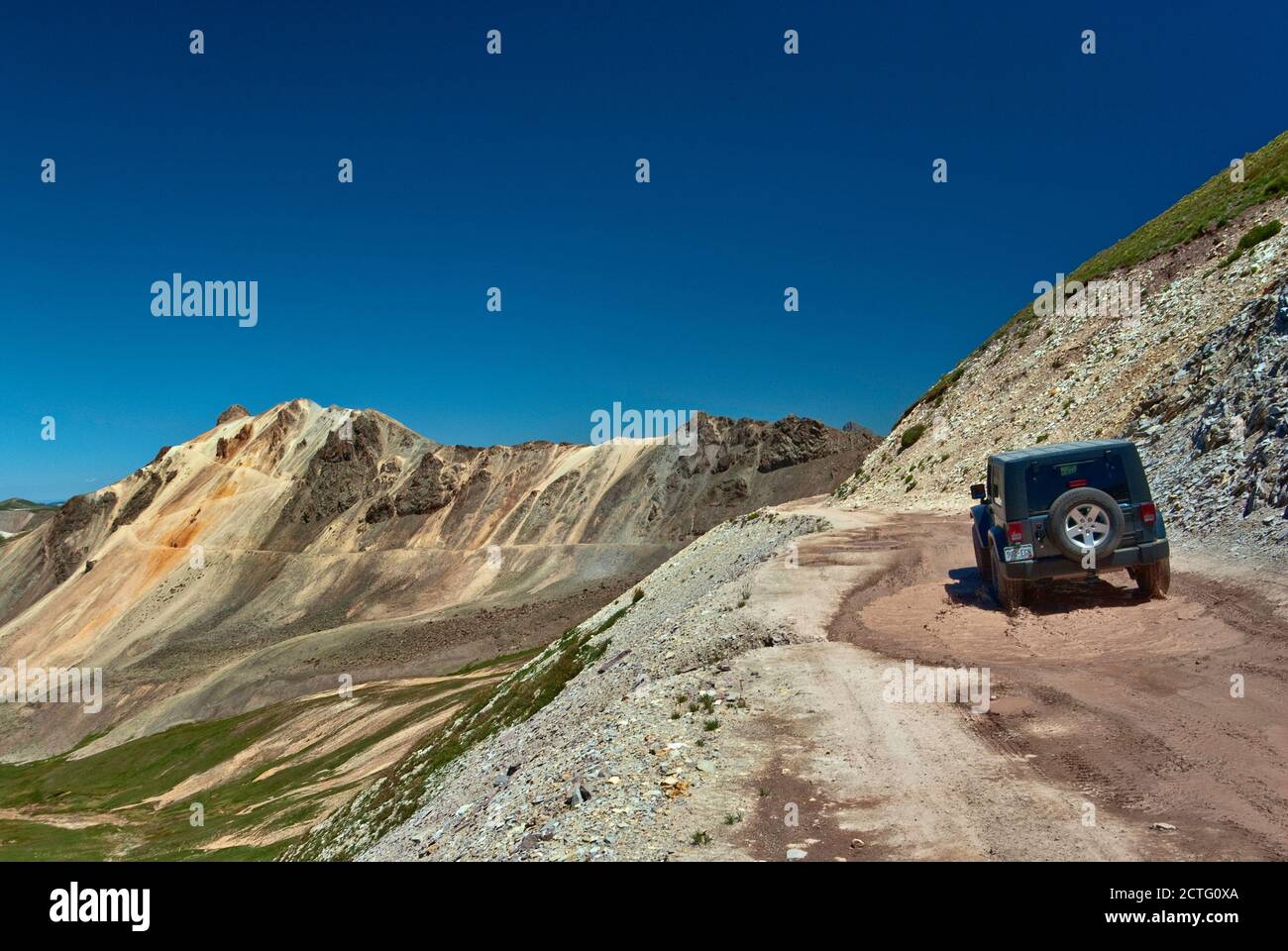 Jeep crossing pool of water on Alpine Loop road near Engineer Pass, San ...