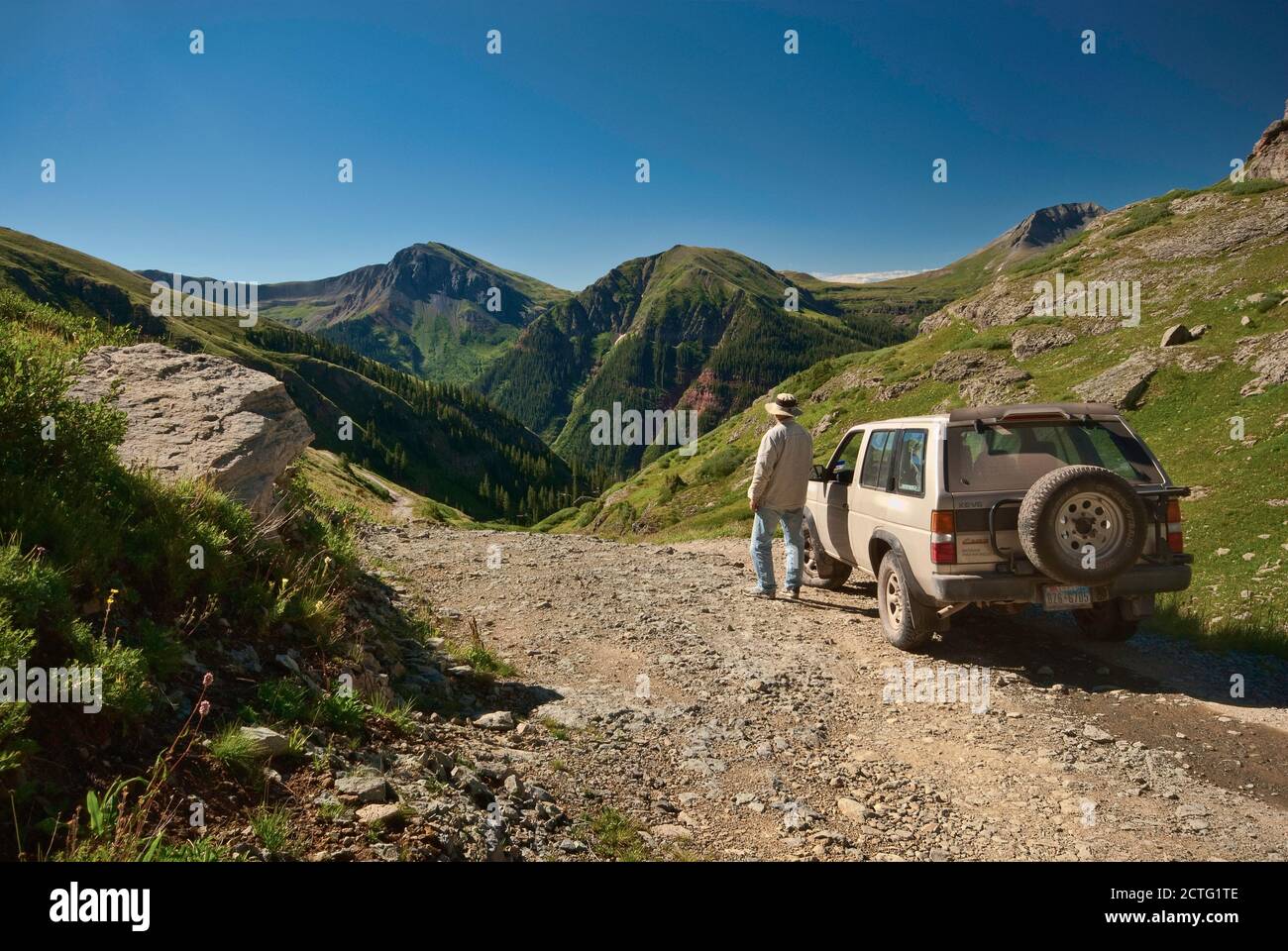 Visitor, 4WD vehicle on road to Clear Lake with view of San Juan ...