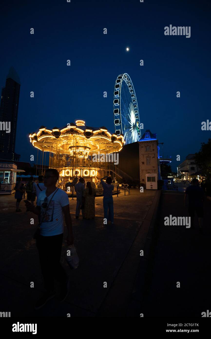 Carousel and big wheel moon light Stock Photo - Alamy