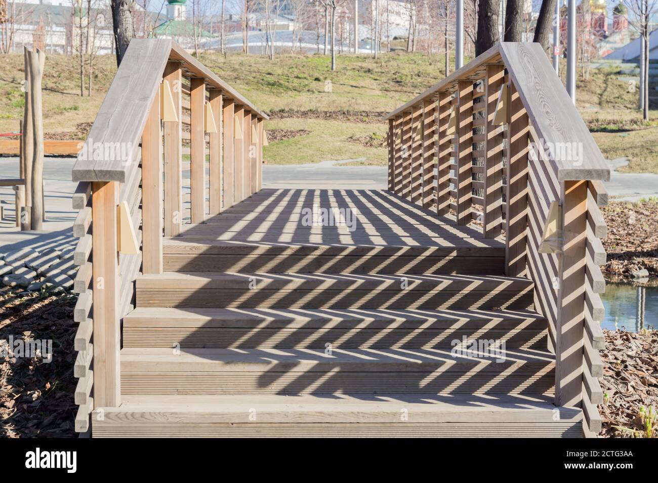 Wooden bridge in the park and Railing hard Shadows Stock Photo - Alamy