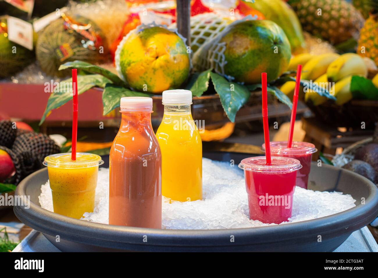 Closeup of a beautiful stand with crushed ice and colorful juices Stock ...