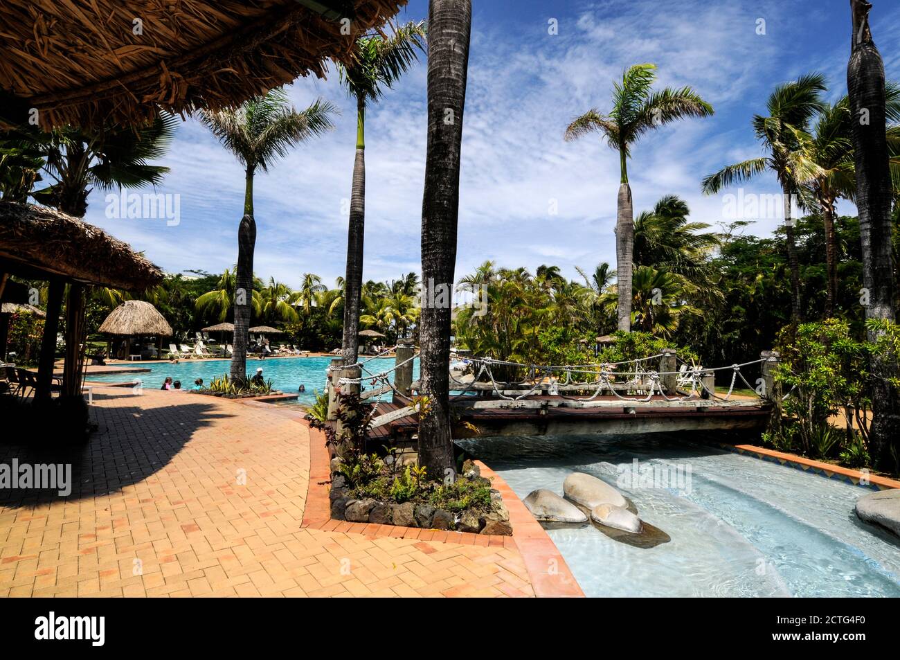 A large swimming pool area with a footbridge at the Outriggers on the ...