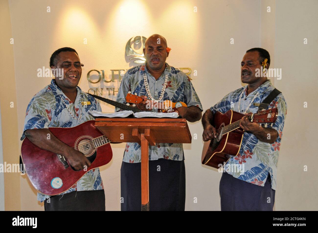 A trio of Fijian musicians, performing as a welcome to hotel guests in ...