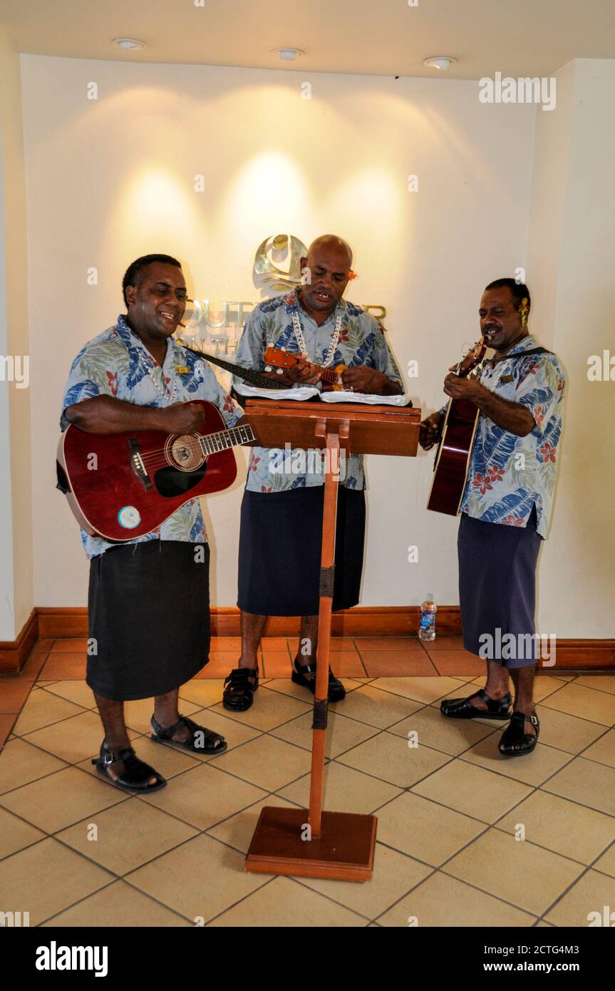 A trio of Fijian musicians, performing as a welcome to hotel guests in ...