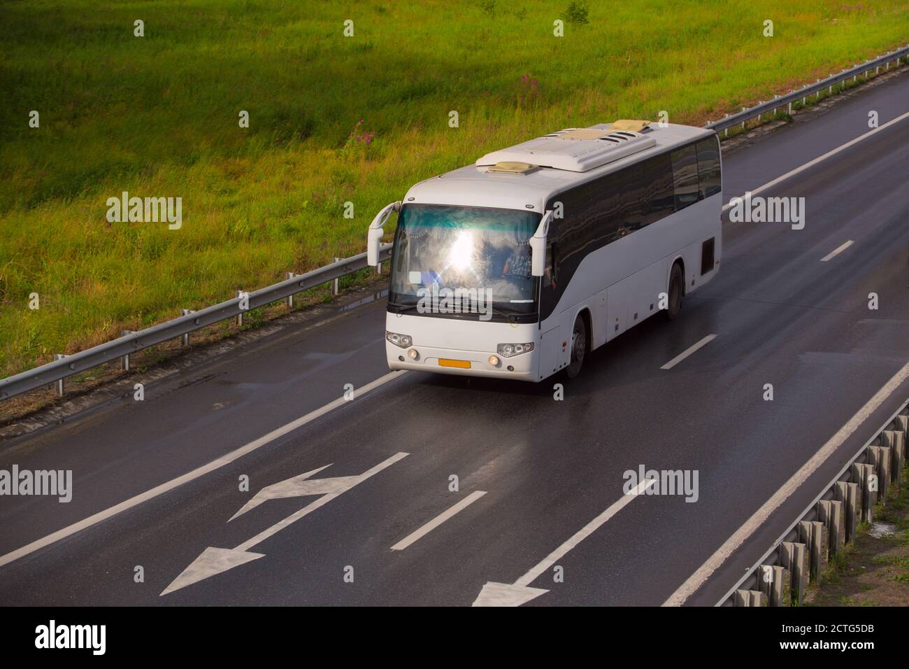 white bus goes on country highway Stock Photo - Alamy