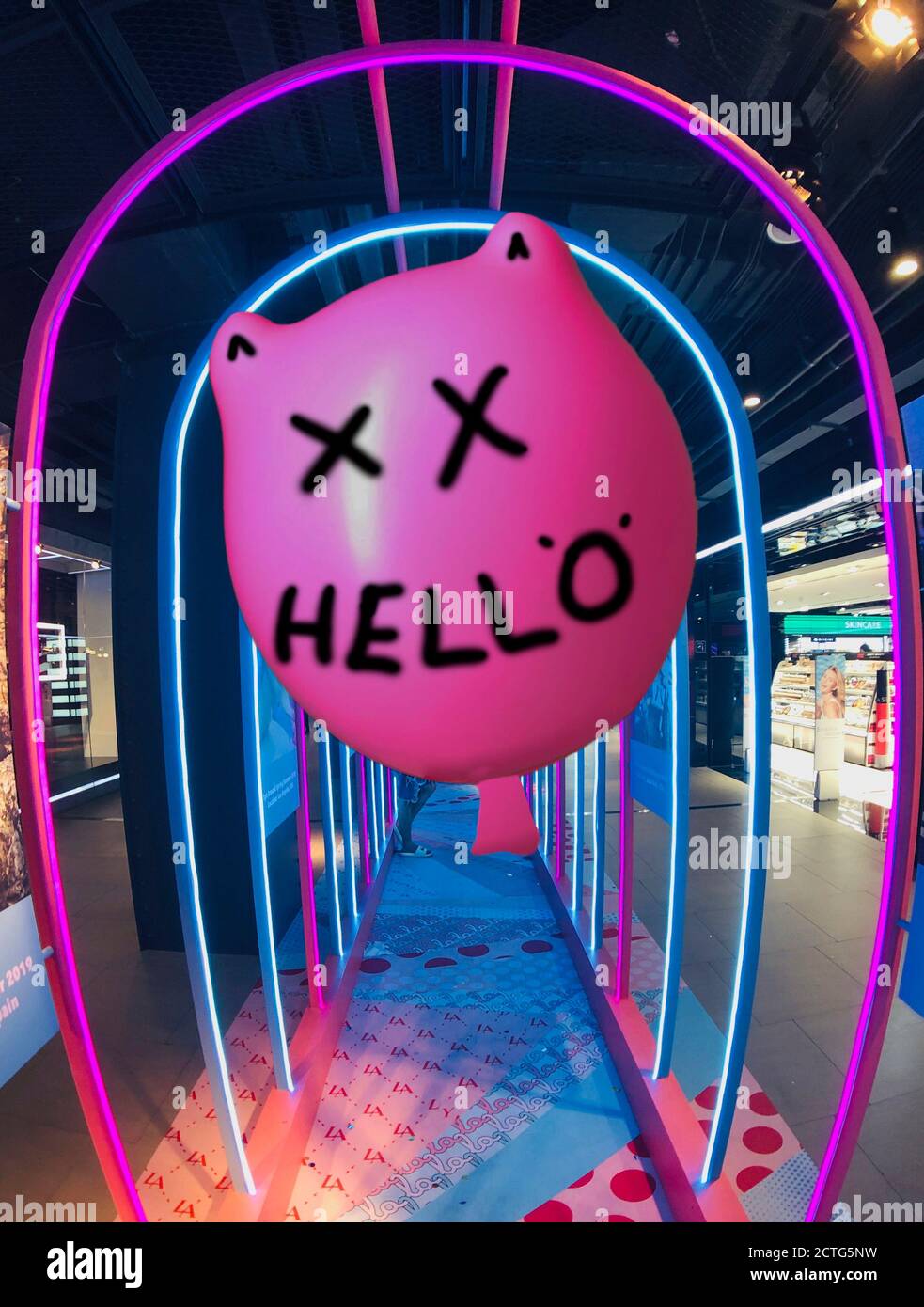 Pink hello ballon with X eyes Stock Photo - Alamy