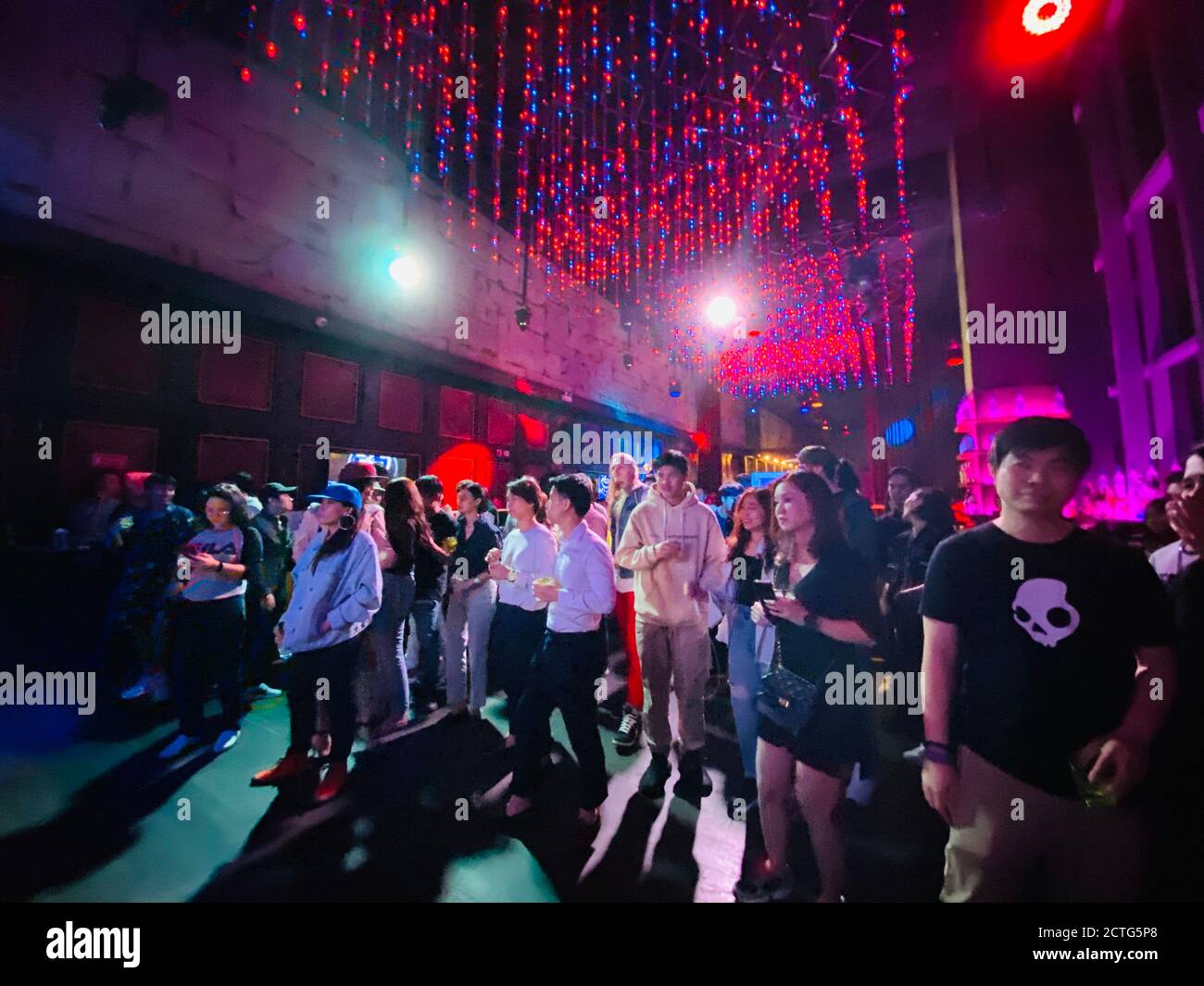 Crowd of young asians in night club Stock Photo - Alamy