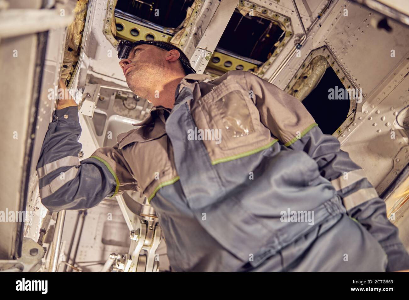 Low angle portrait of confident responsibility engineer in overall ...