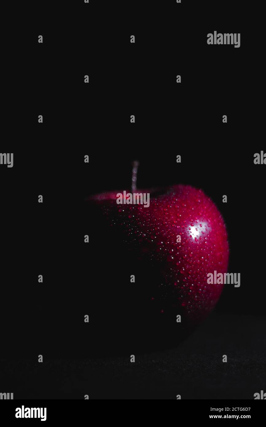 Apple fruit, abstract shadow, black background, red apple, drops of ...