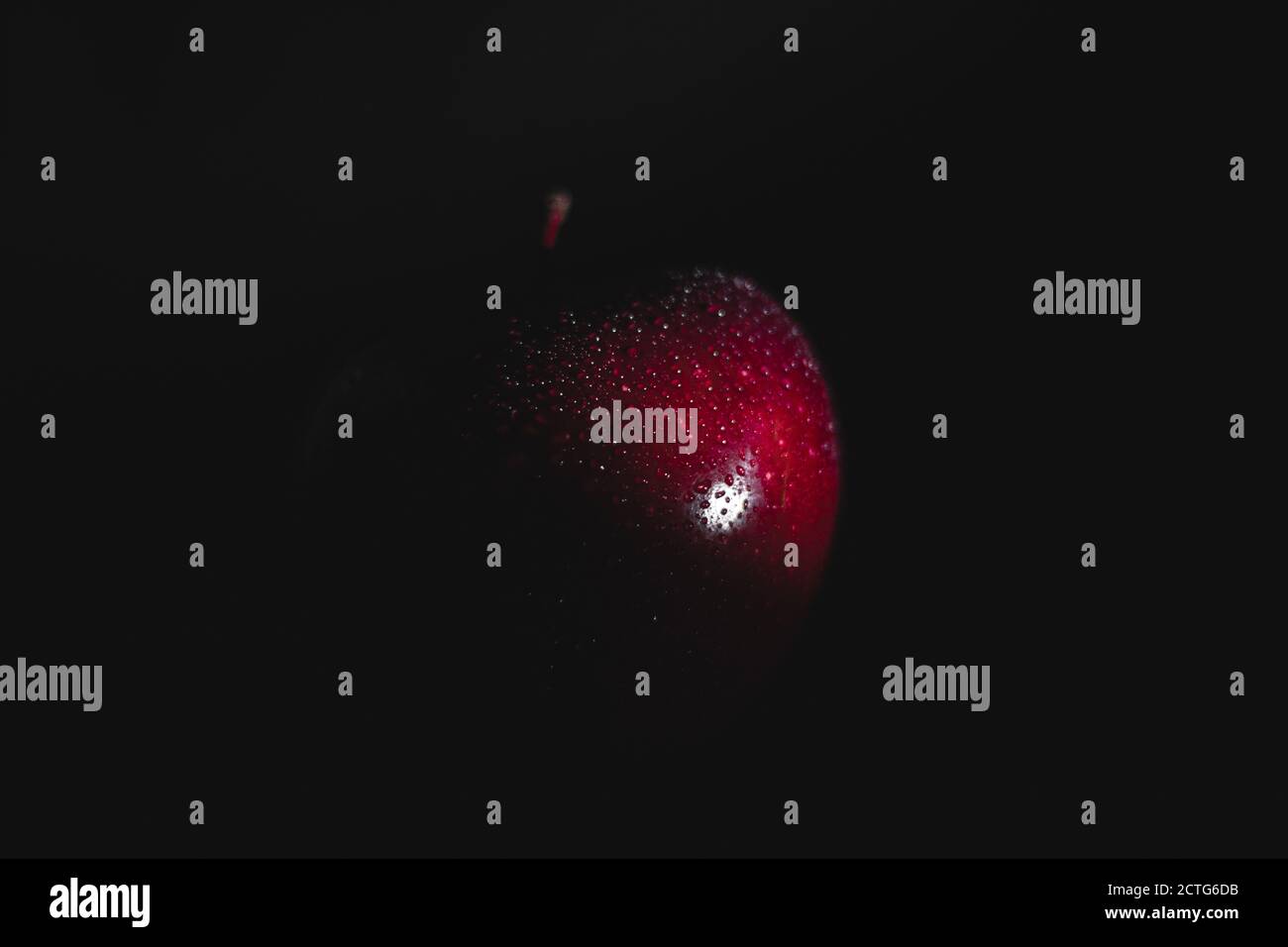 Apple fruit, abstract shadow, black background, red apple, drops of ...