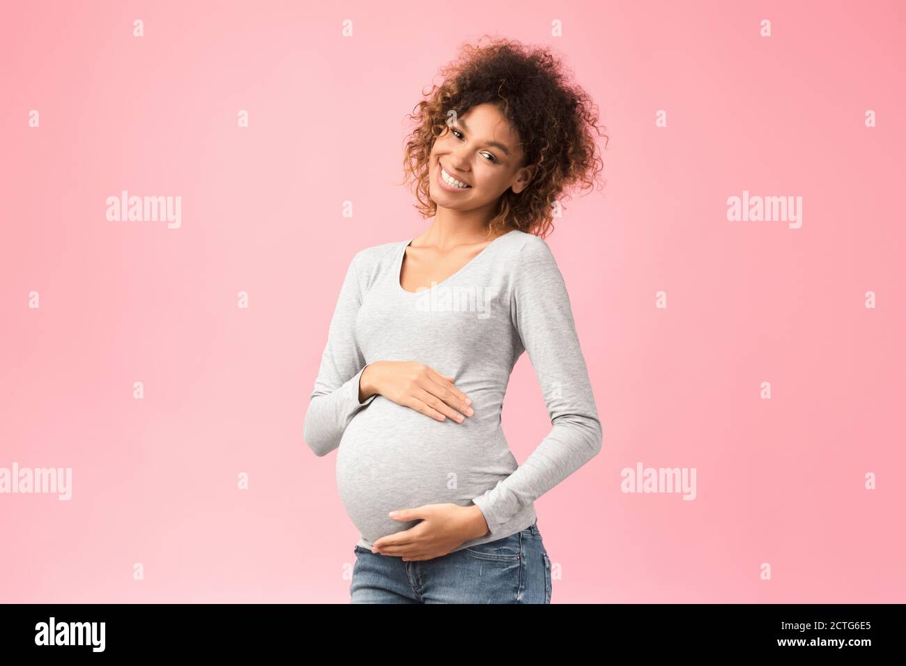 Sweet time of pregnancy. Happy expectant woman hugging her belly Stock ...