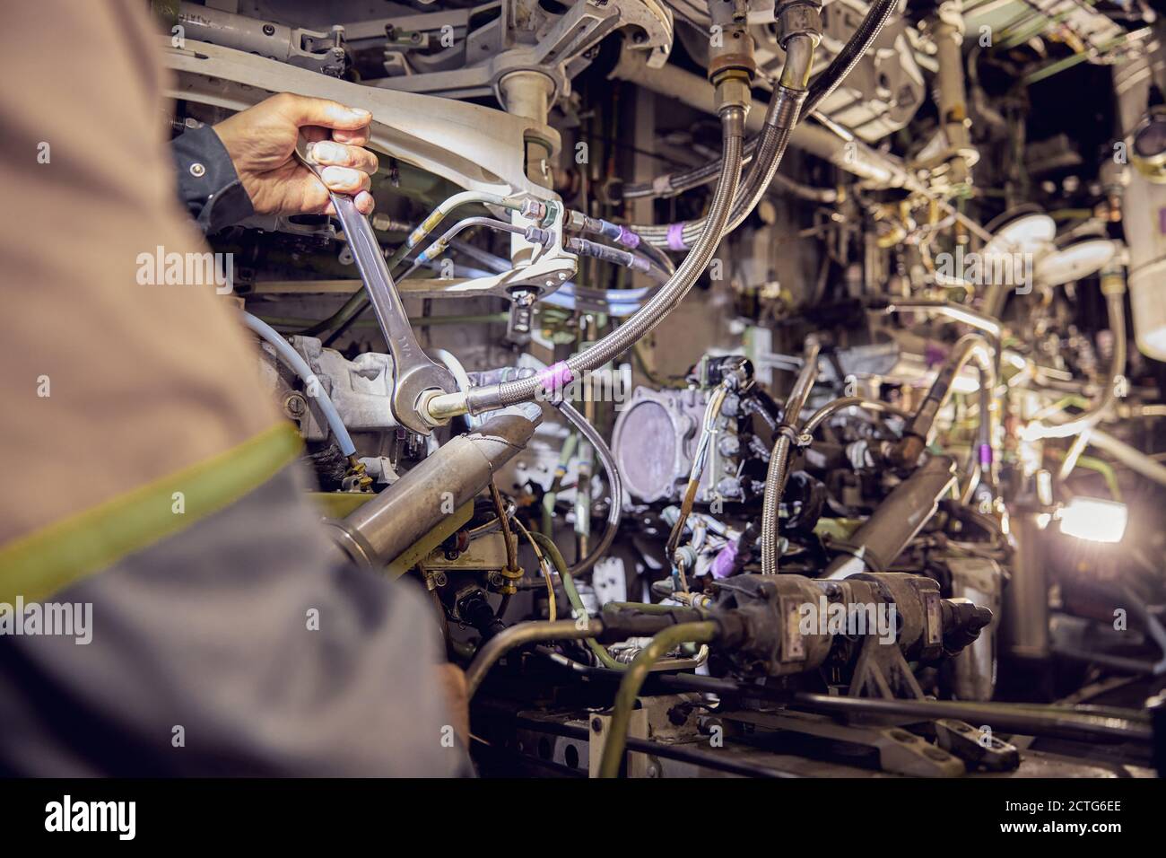 Cropped head portrait of aircraft engineer inside of airplane repairing ...