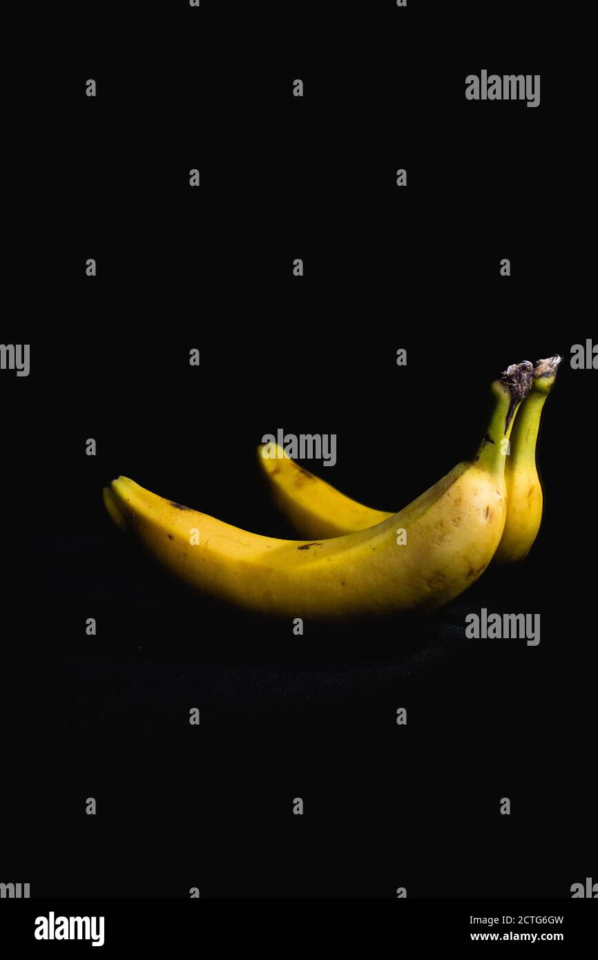 Banana yellow fruit reflecting in a mirror, black dark background Stock ...